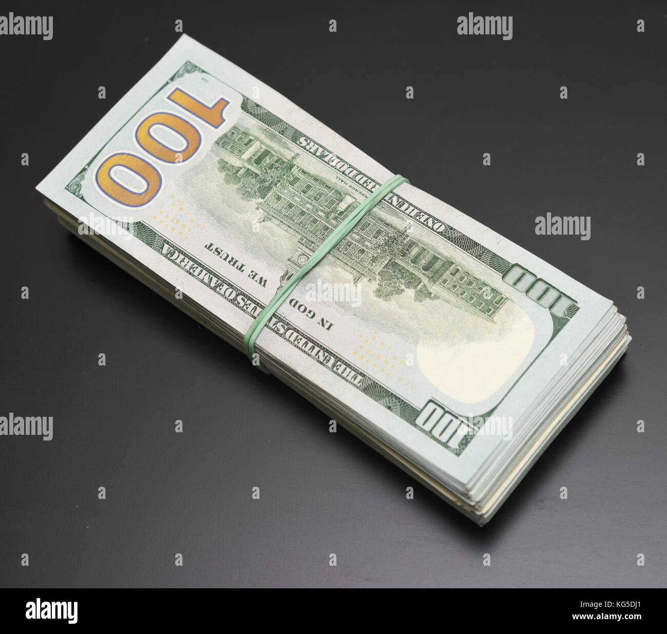 Stack of one hundred dollars on a black background Stock Photo - Alamy