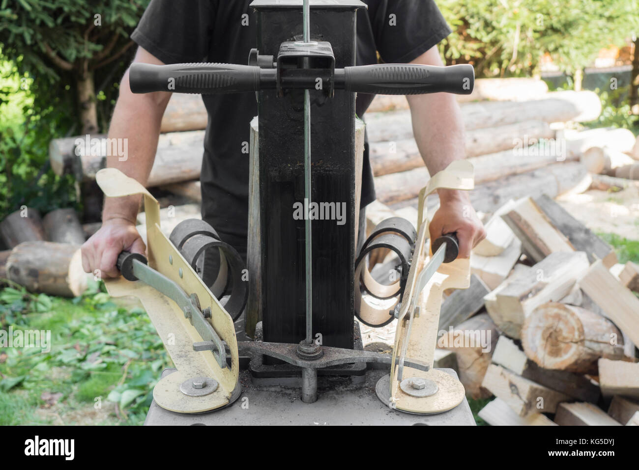 Firewood split with wooden splitter Stock Photo - Alamy