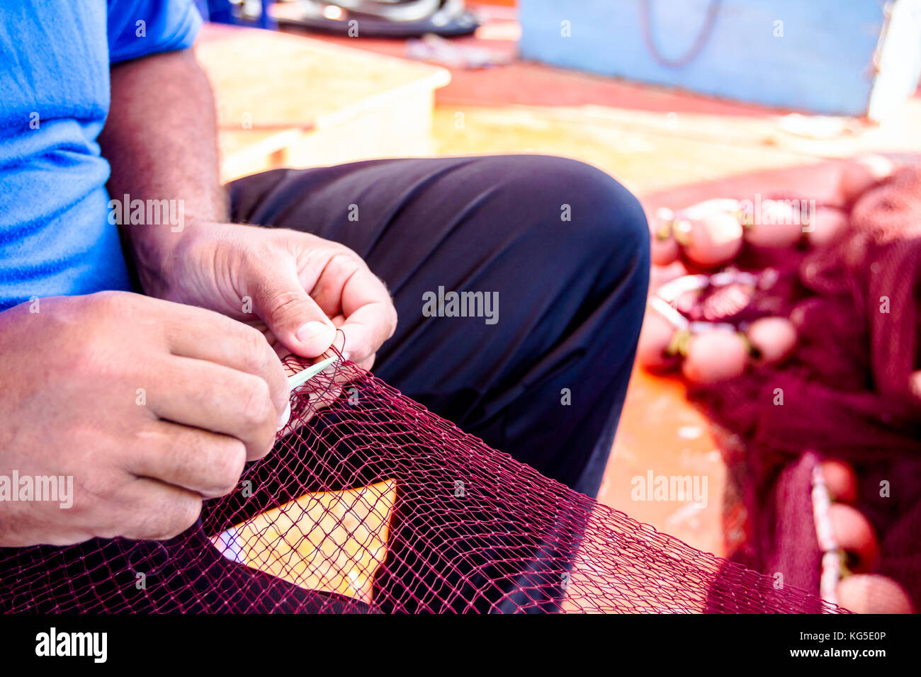 Hands repairing netting hi-res stock photography and images - Alamy