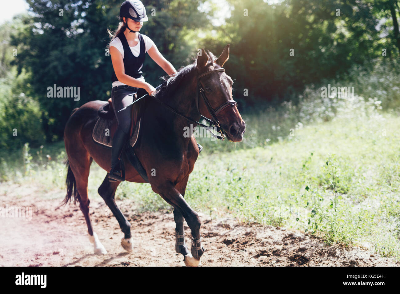 Picture of young pretty girl riding her horse Stock Photo - Alamy