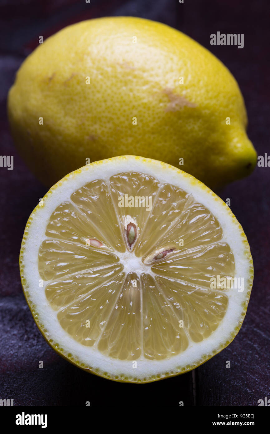 Lemon cut open on mahogany wooden background Stock Photo - Alamy