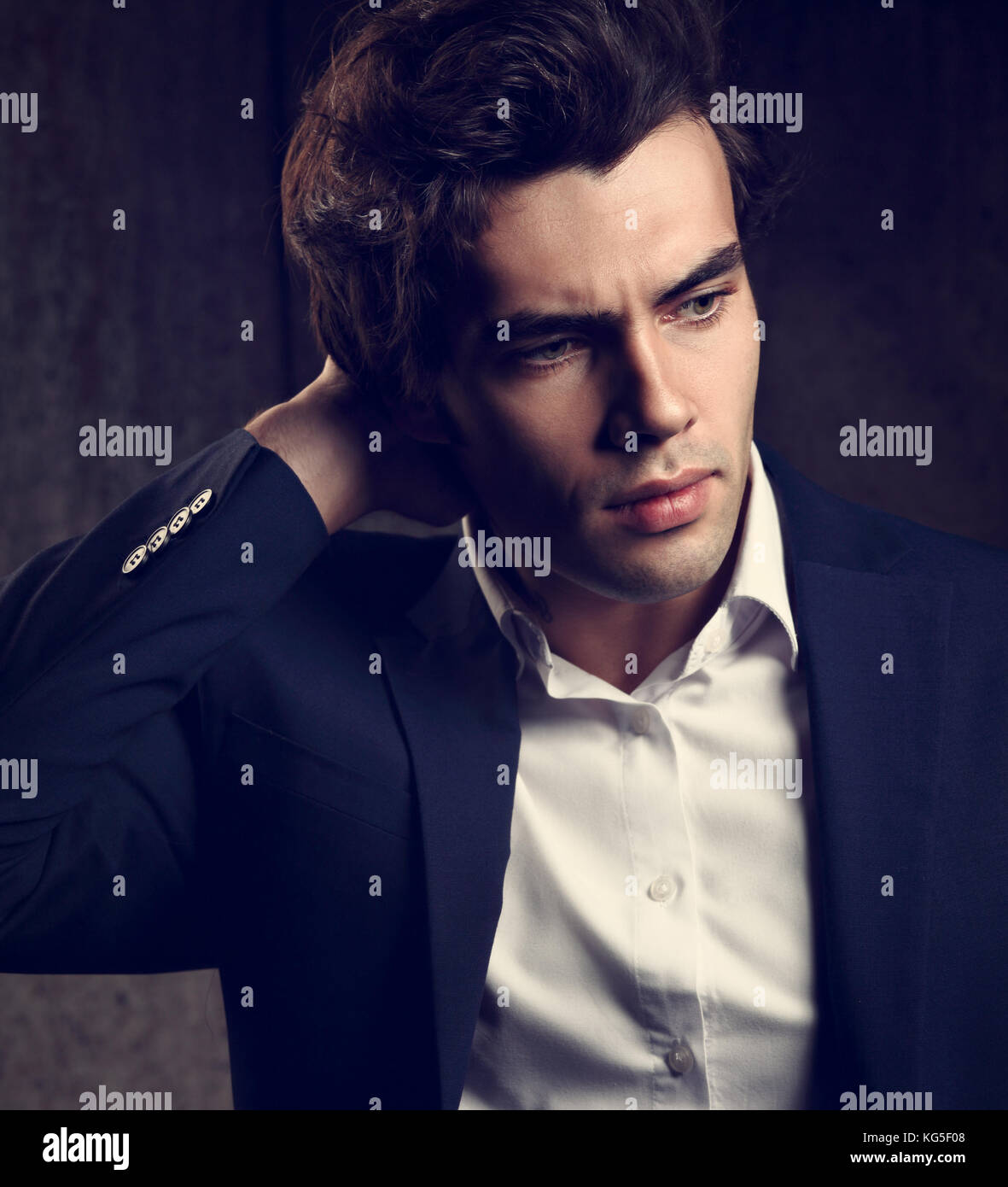 Confident thinking business man with anxious look in blue fashion suit ...