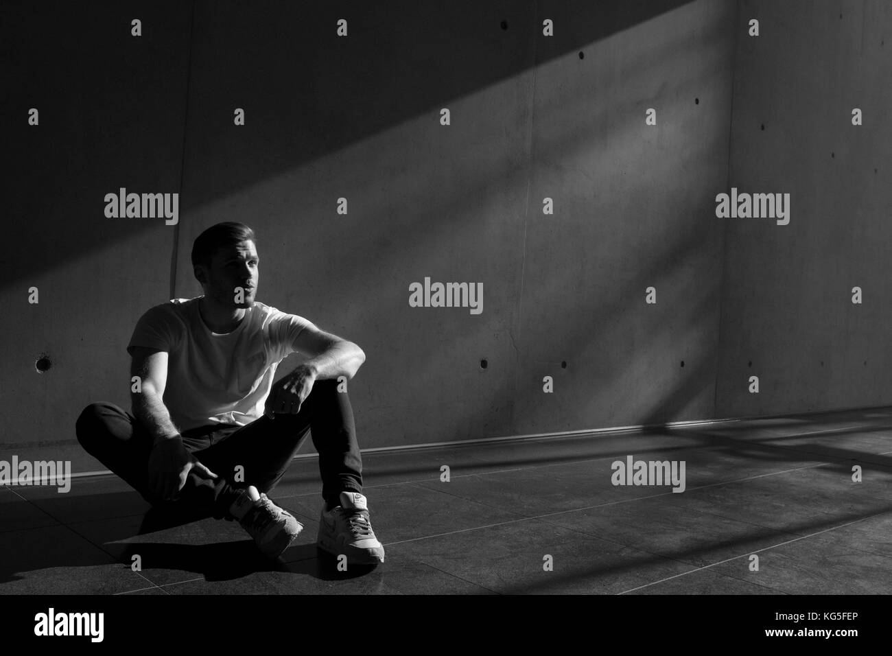 Young man, sit, inside, s/w Stock Photo - Alamy