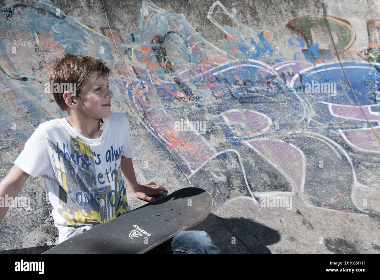 Boy with skateboard in the skate park Stock Photo - Alamy