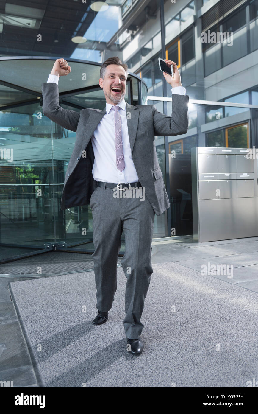 Businessman rejoices with upraised arms hi-res stock photography and ...