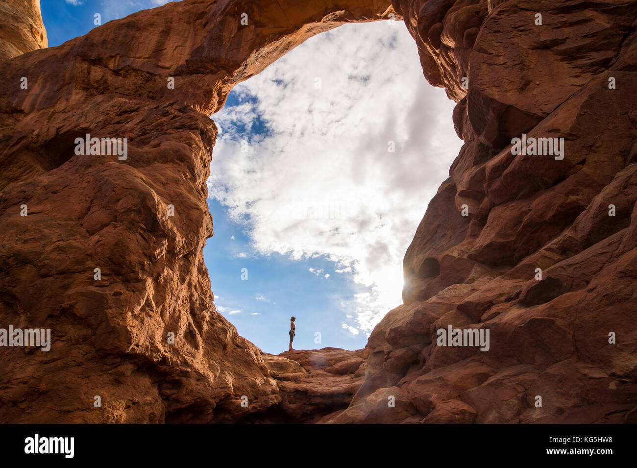 Woman standing rock arch hi-res stock photography and images - Alamy