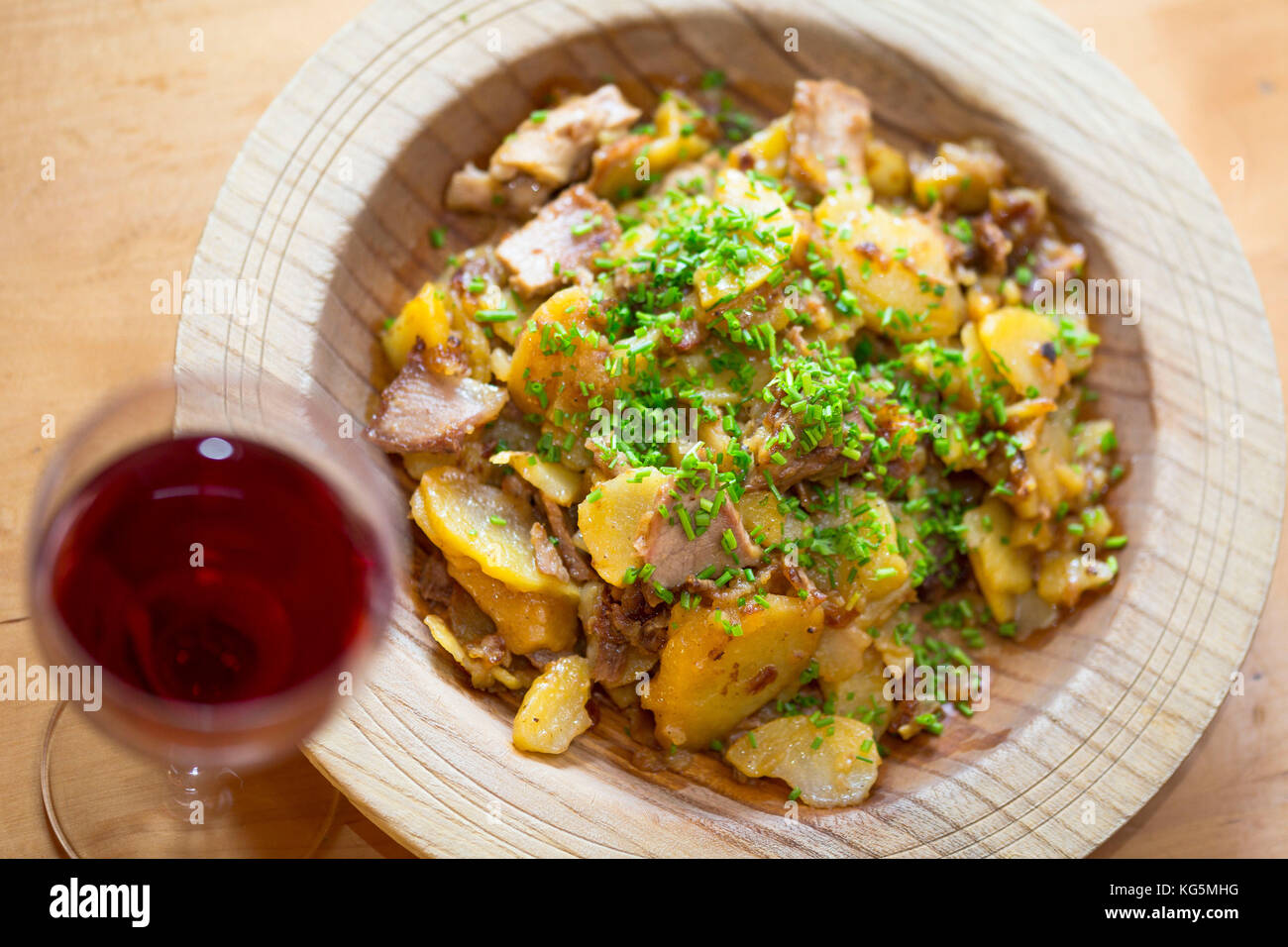 a plate of gröstl, a typical tyrolean food with meat, onions, chives ...