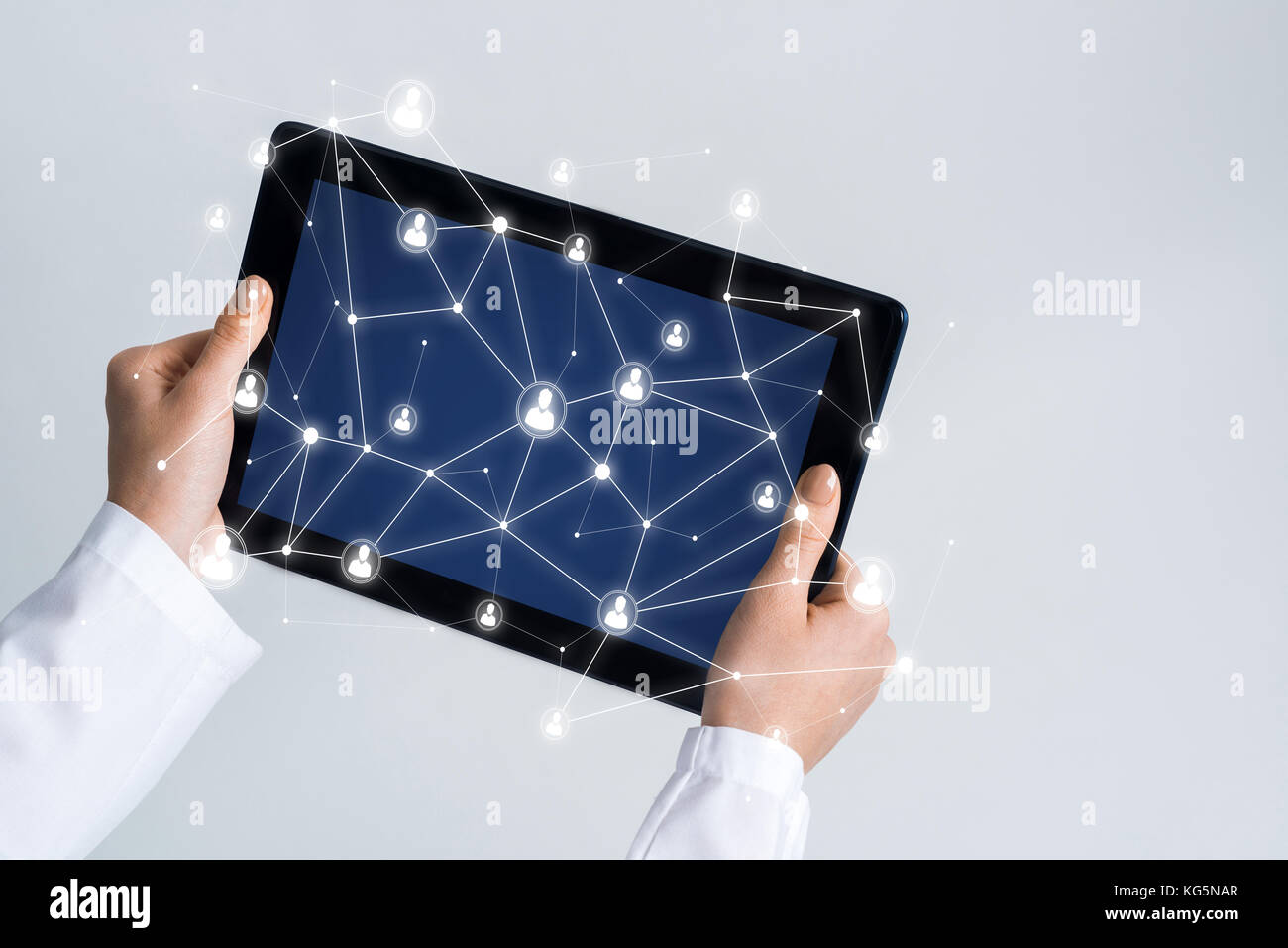 Tablet pc device with connection lines on screen in hands of doctor ...