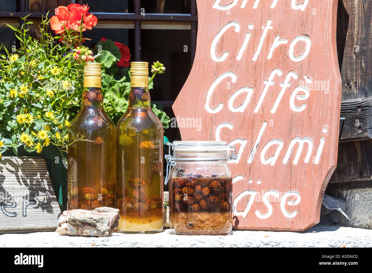 Bottles of grappa typical liquor at food shop, San Romerio Alp, Brusio ...