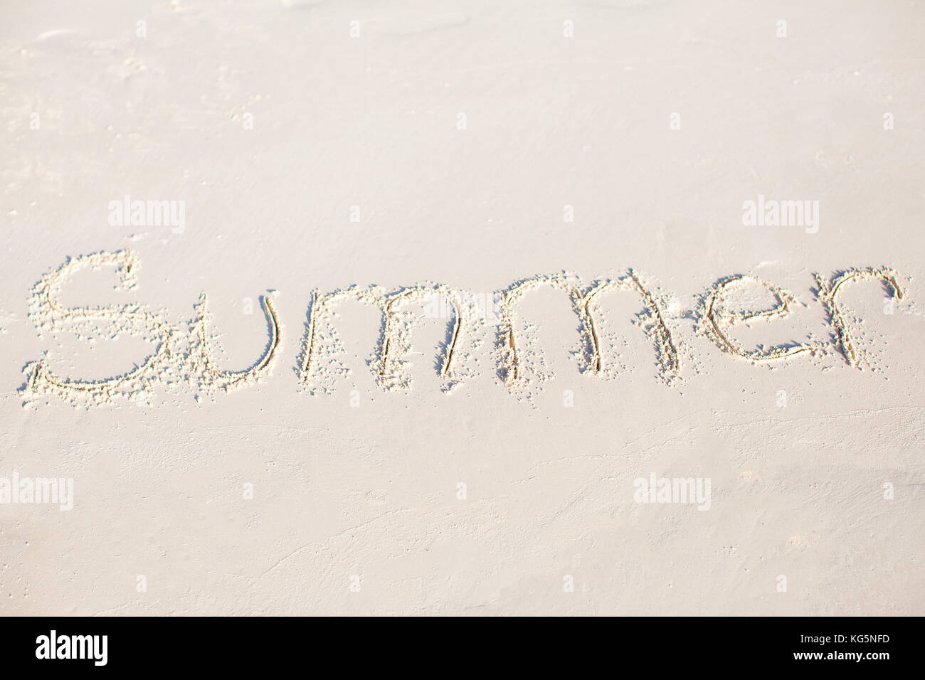 Word Summer handwritten on sand beach with soft ocean wave on ...