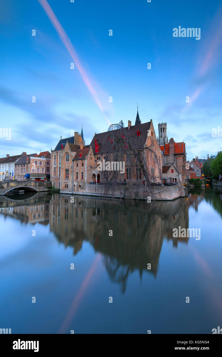 The medieval Belfry and historic buildings are reflected in ...