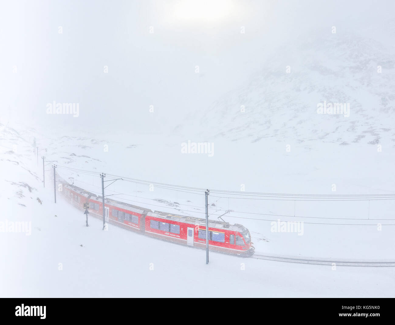 Bernina express train at bernina pass during a snowstorm hi-res stock ...