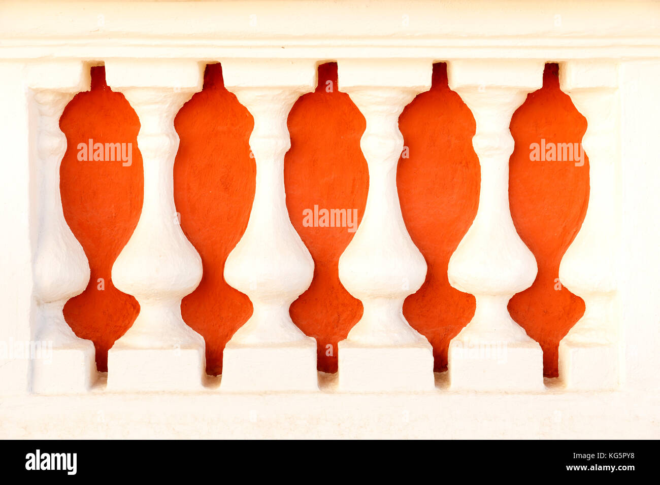 Closeup of white architectural columns in front of red background Stock ...