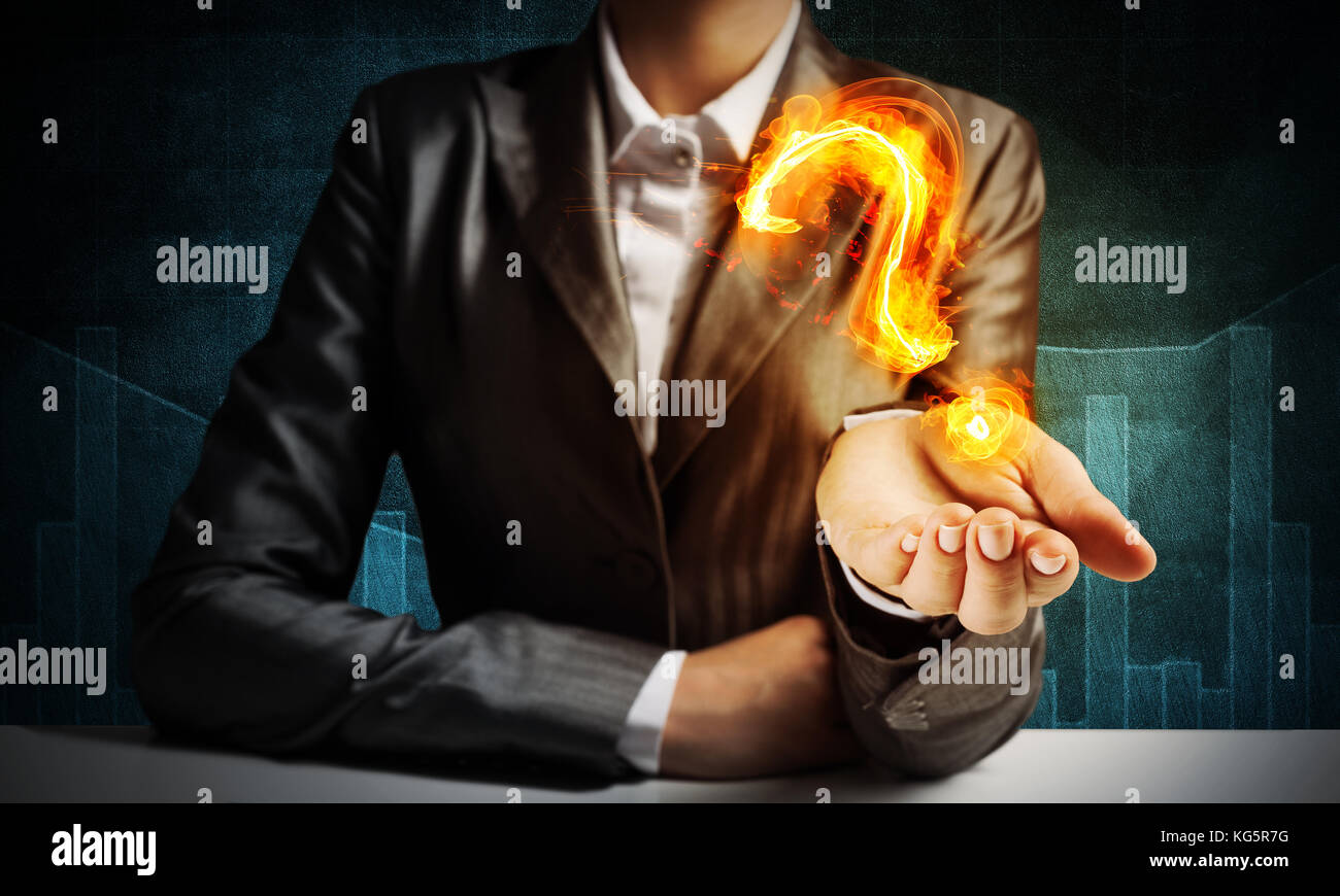 Cropped image of businessman in suit presenting flaming question mark ...