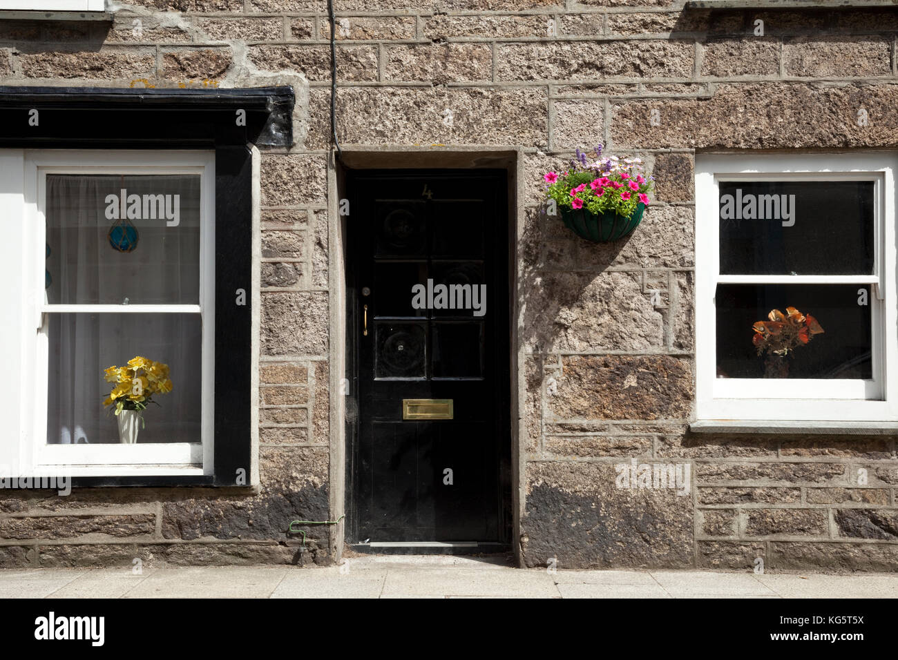 Flowers adorn the windows and wall of a home in Saint Just, Cornwall ...