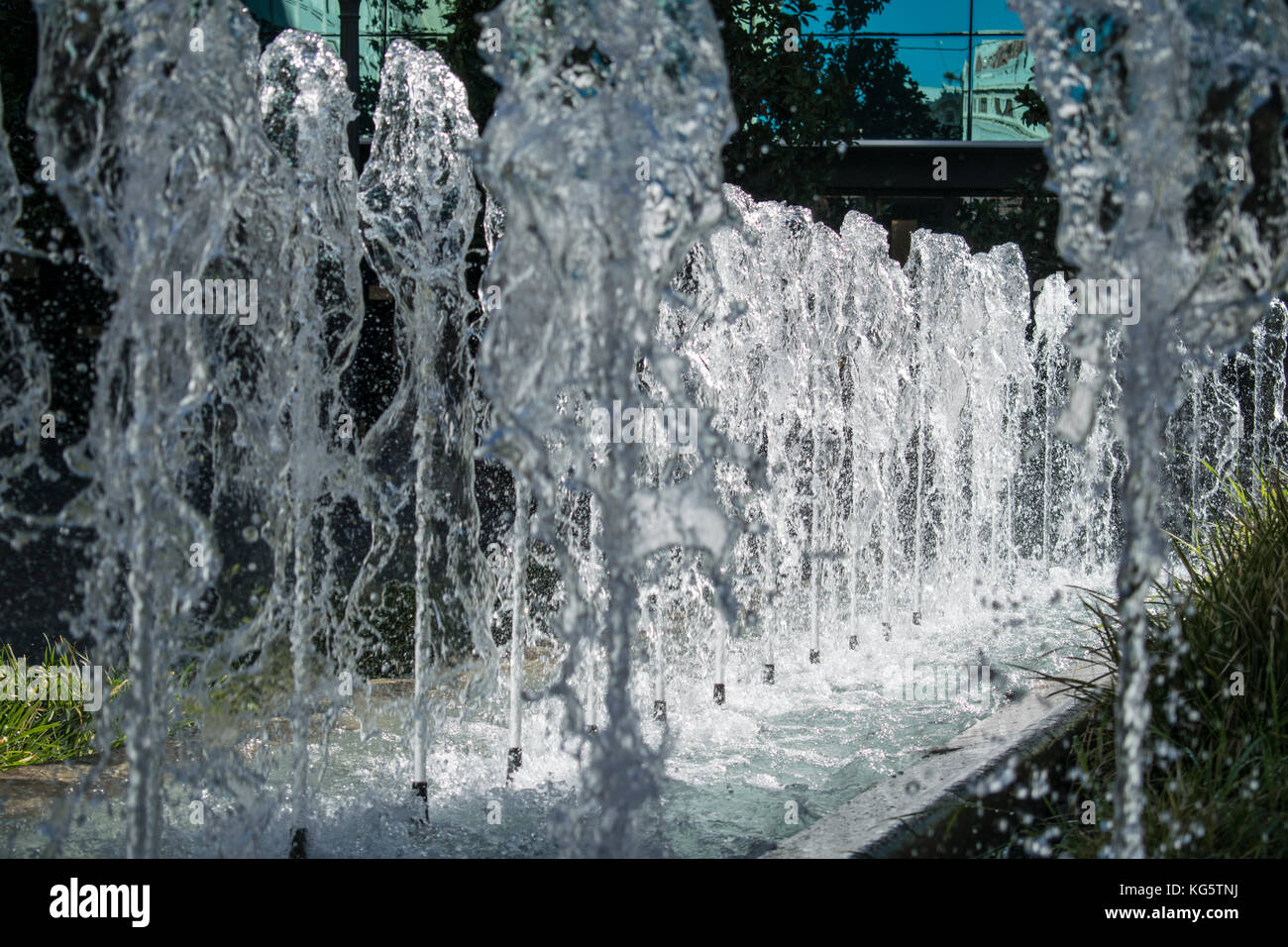 a view through the columns of water of a fountain Stock Photo - Alamy