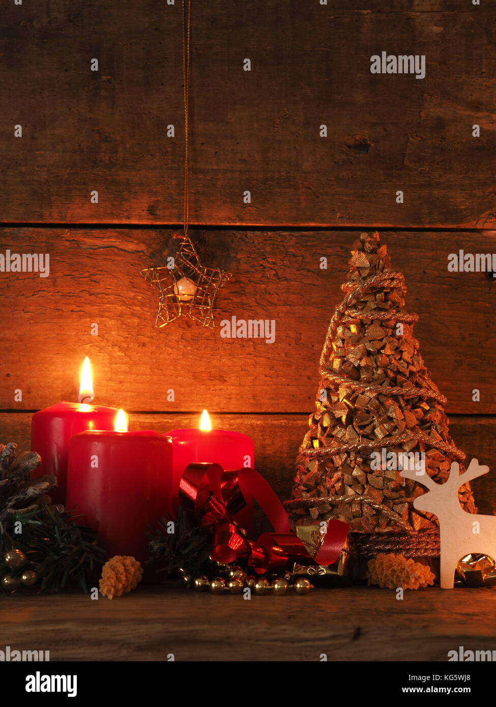 Romantic Christmas background with three burning candles on a wooden ...