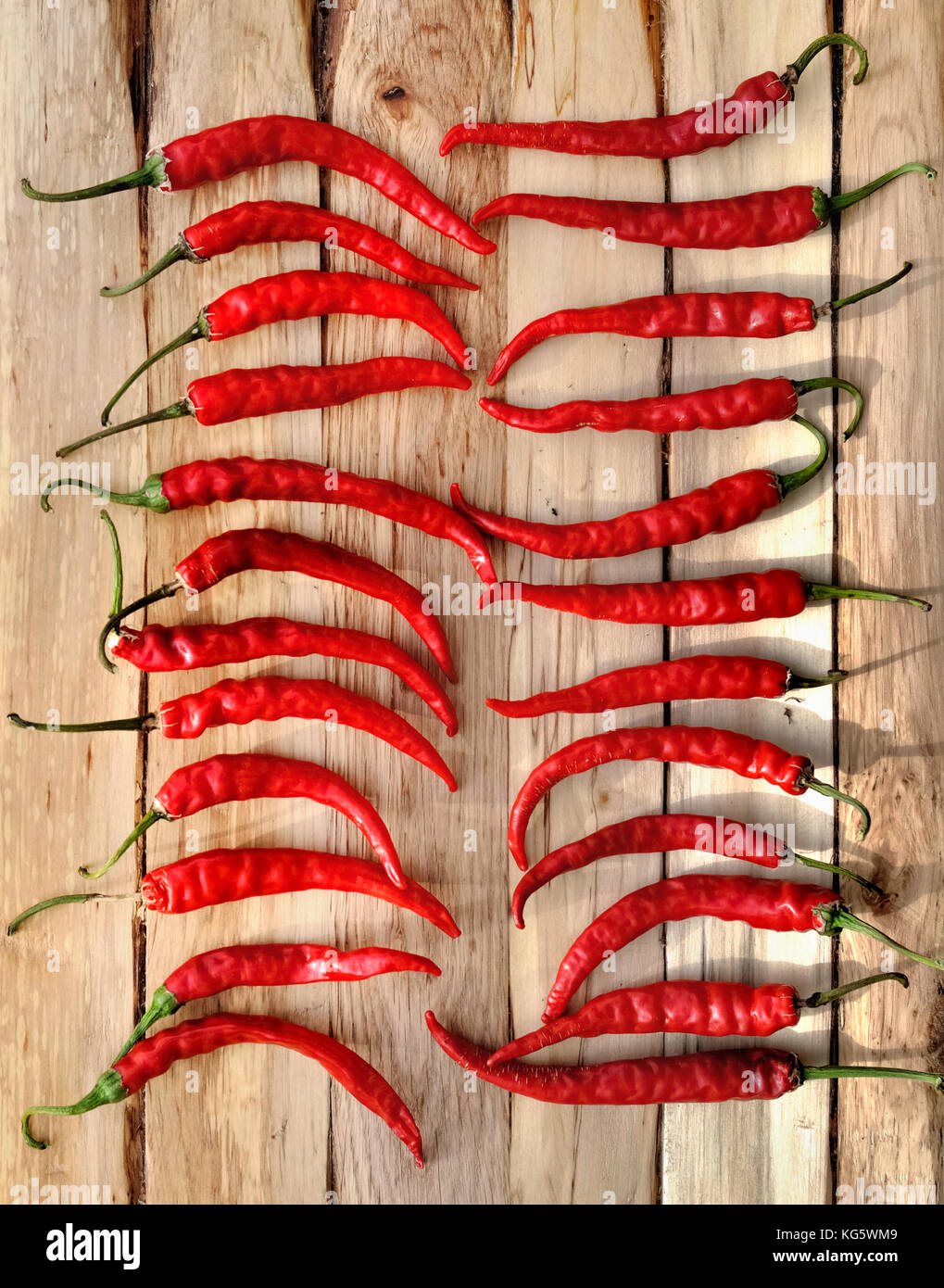 top view on red hot peppers aligned on a plank Stock Photo - Alamy