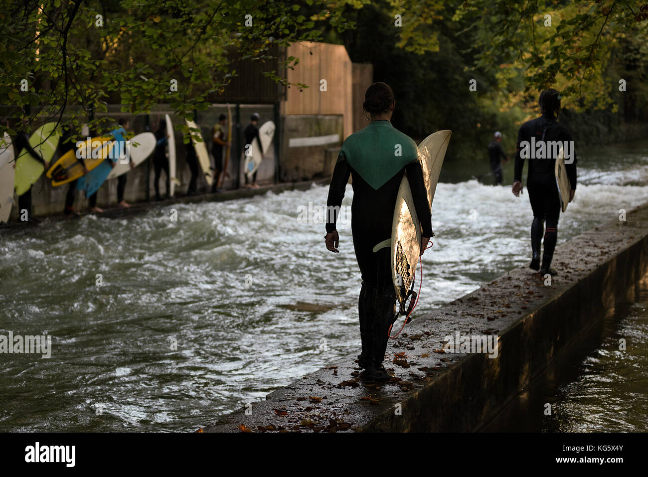 Surfers at the E2 Kleine Eisbachwelle River Surfing spot at Munich ...