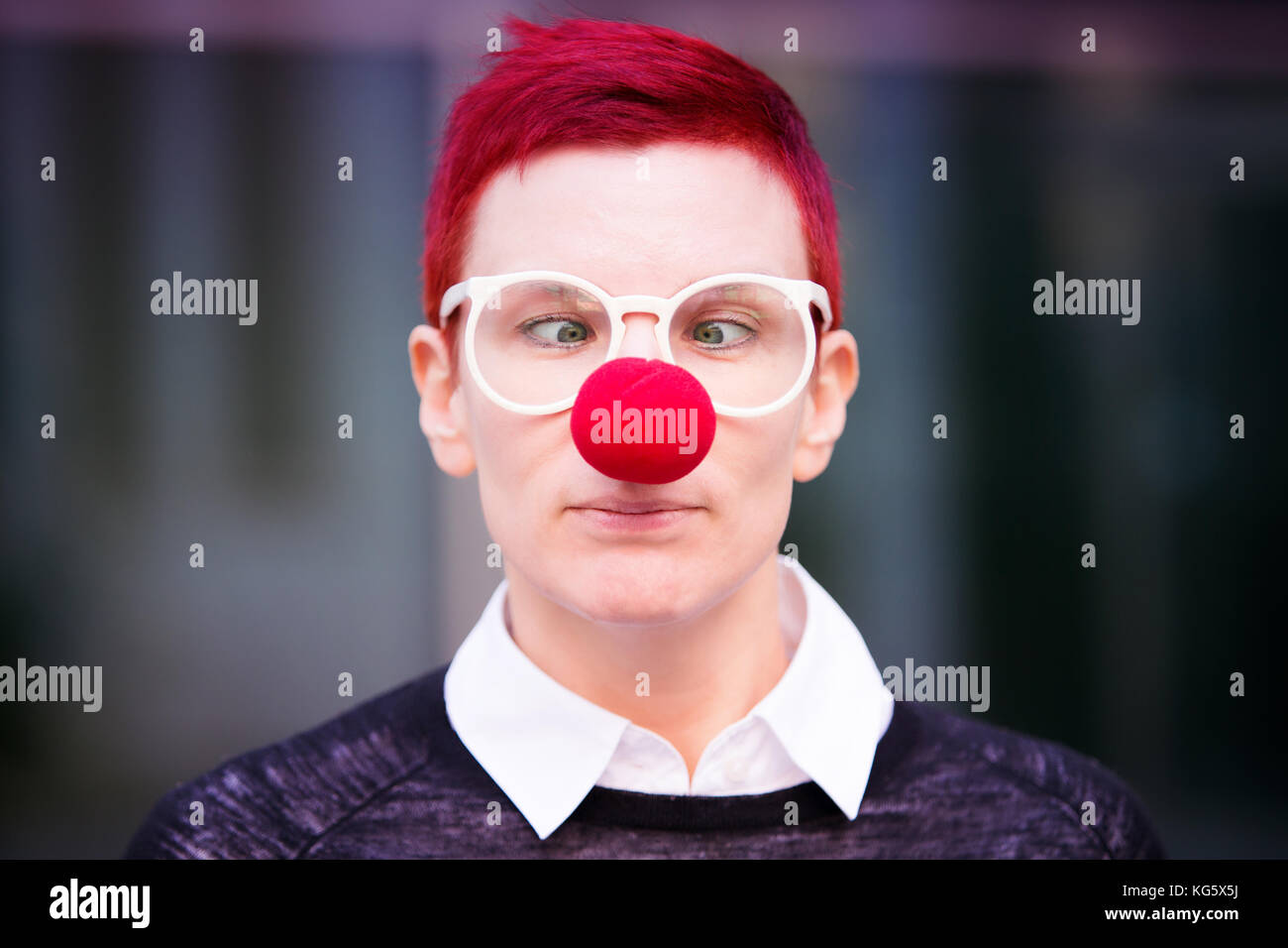 portrait of red-haired beautiful woman with red nose and cross-eyed ...