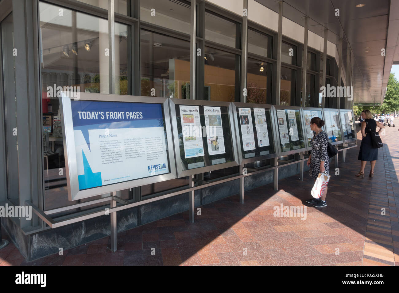 Line of daily newspapers outside the Newseum interactive museum in ...