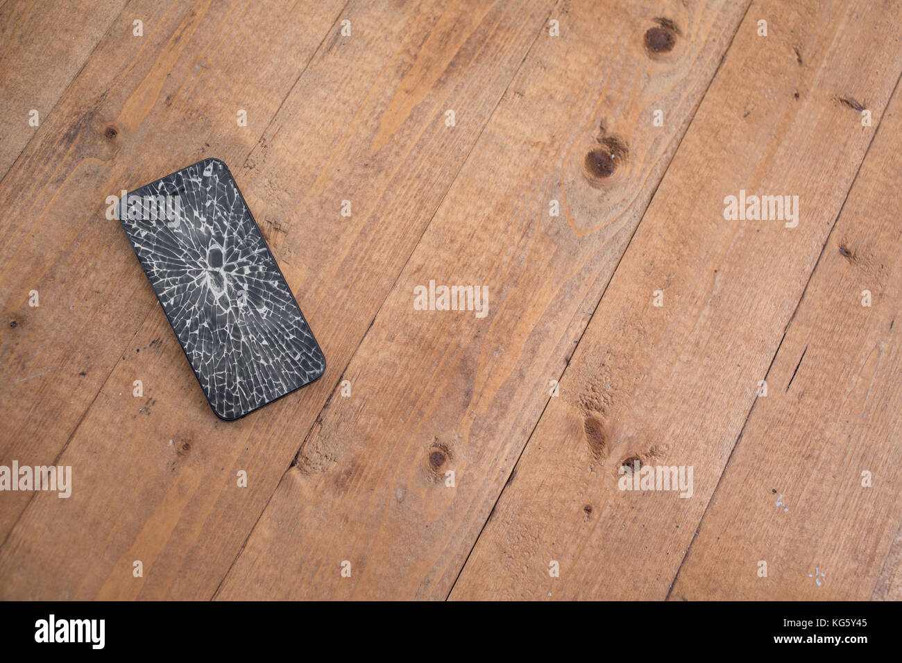 Crushed smartphone on a wooden table Stock Photo - Alamy