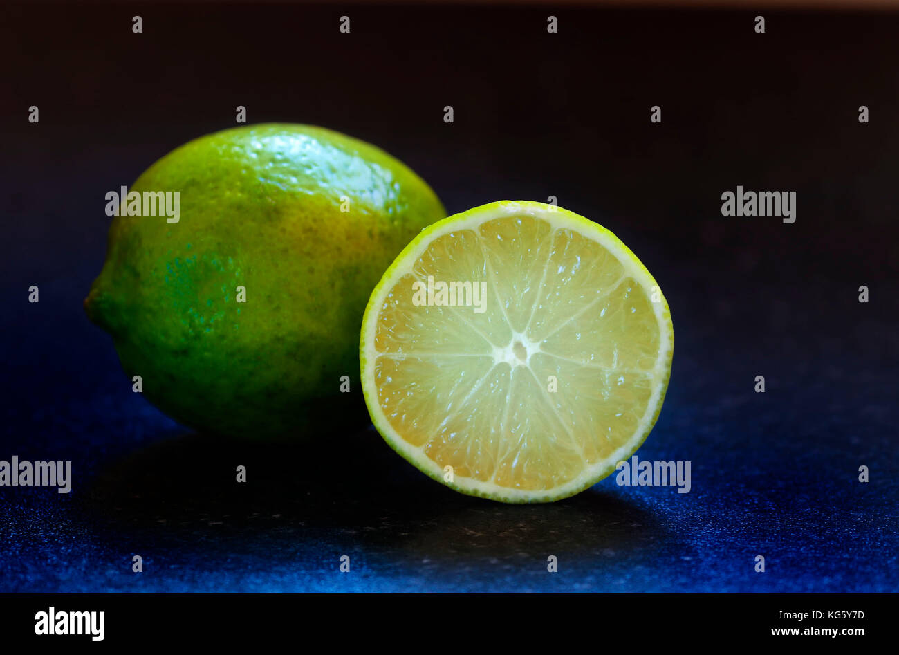 Lime still-life on black background Stock Photo - Alamy