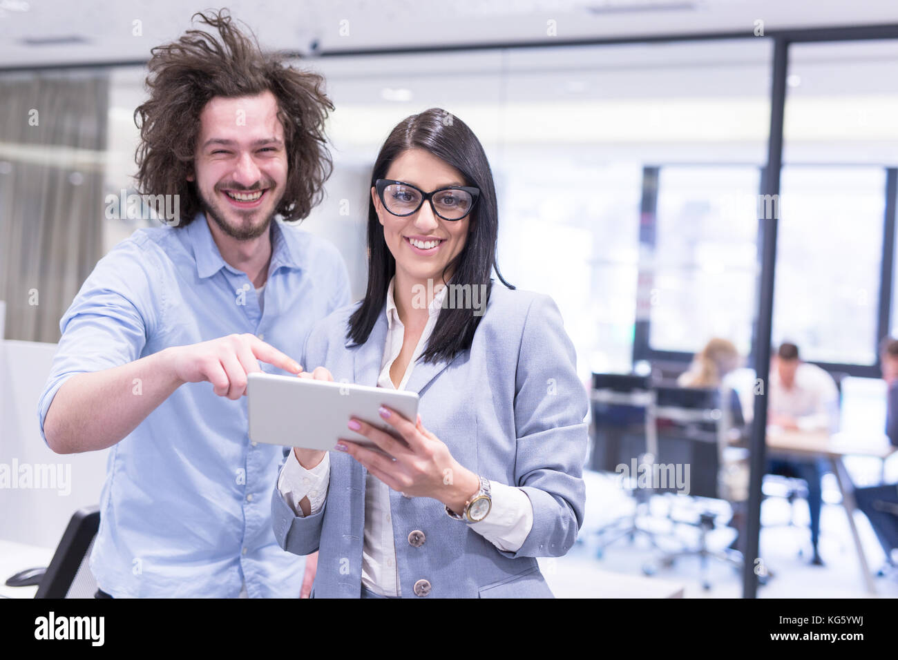 business people using tablet computer while preparing for next meeting ...