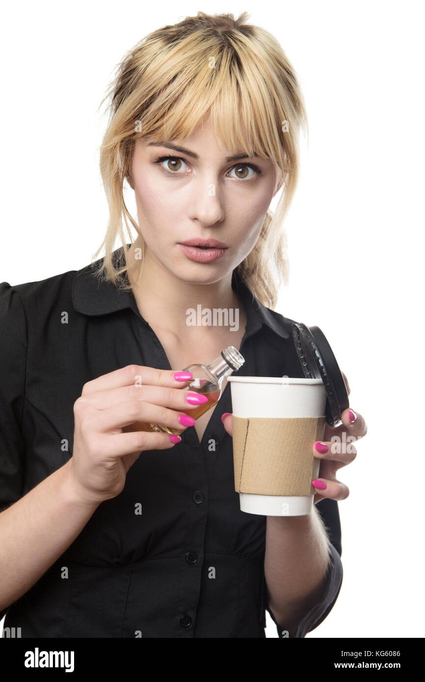blonde haired business woman putting alcohol into her take away cup ...