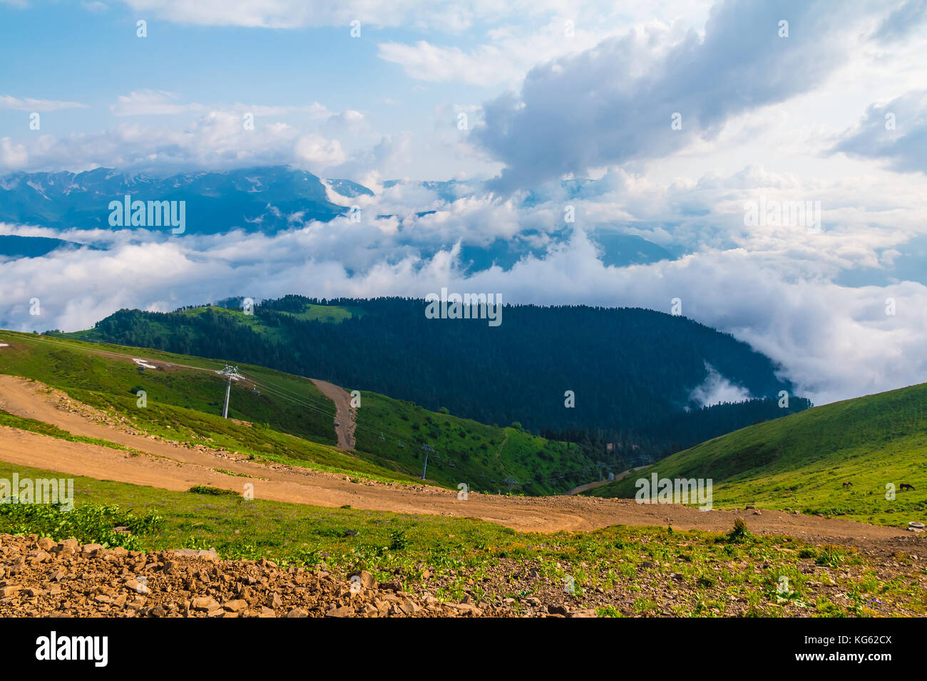 Aerial view of mountainside, valley and clouds from the top of mountain ...