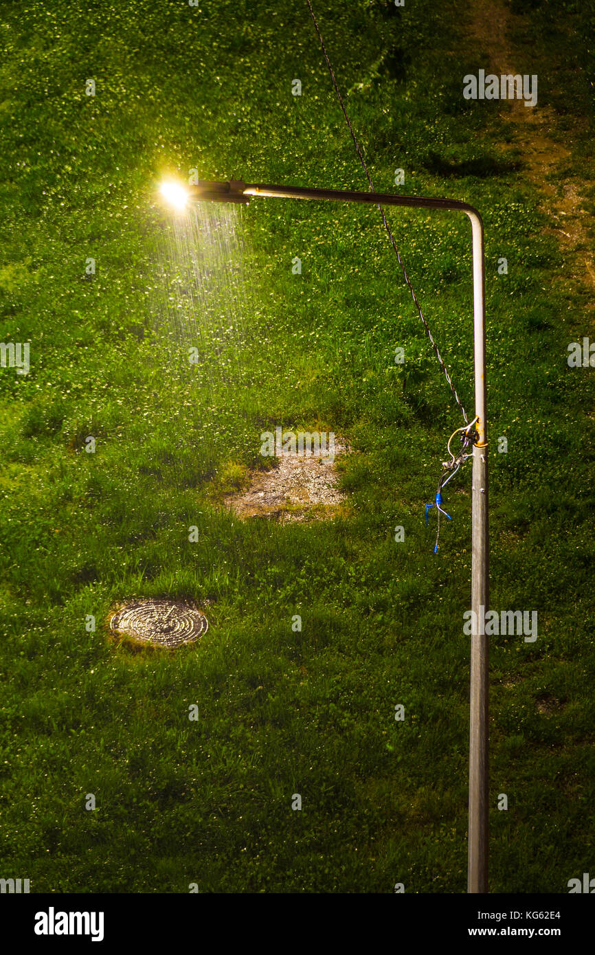 Aerial view of the luminous streetlight in the rain on the background ...