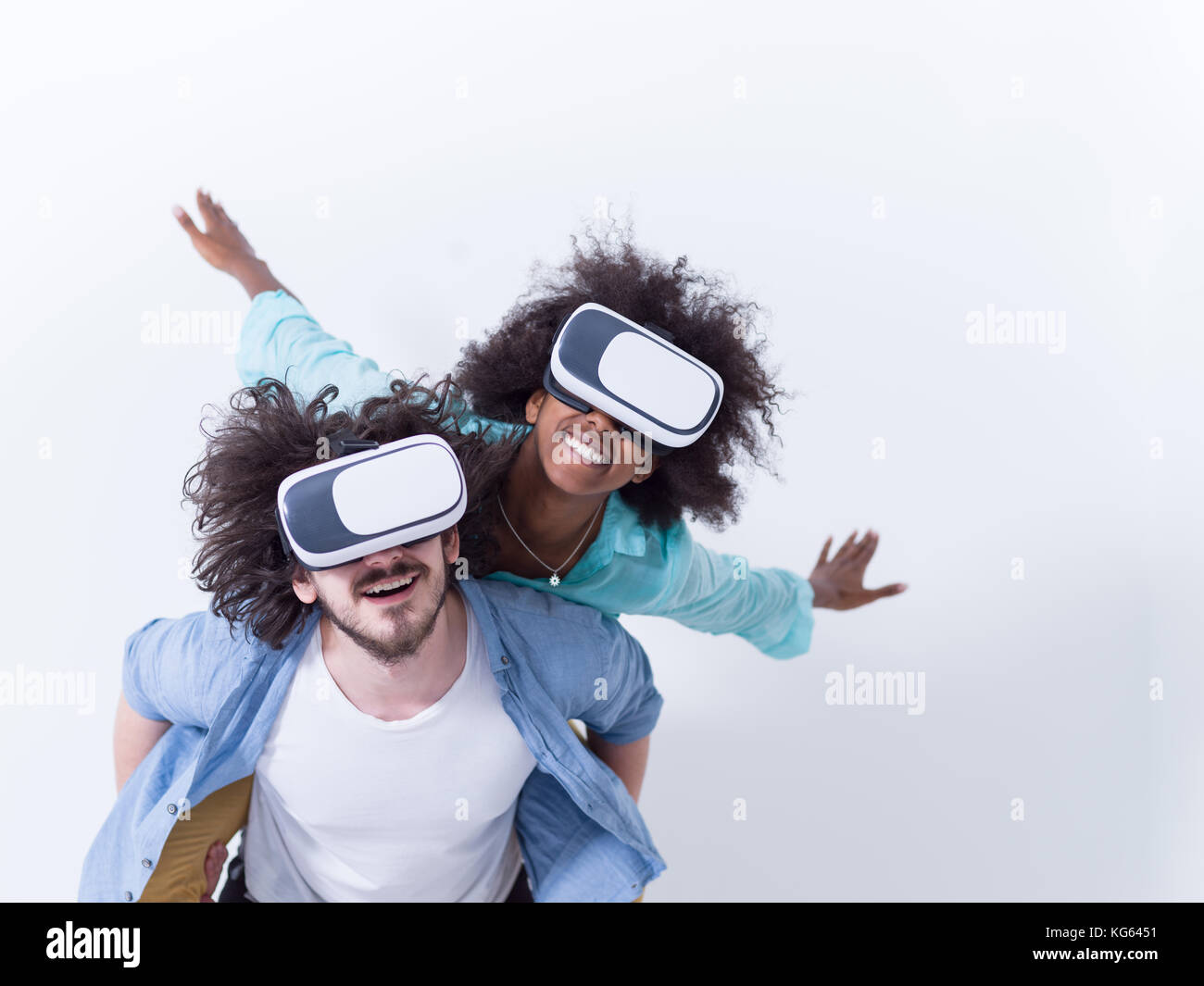 Happy multiethnic couple getting experience using VR headset glasses of ...