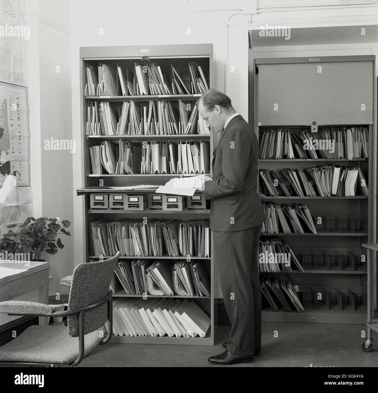 1960s, historical, administration, a male office worker checking ...