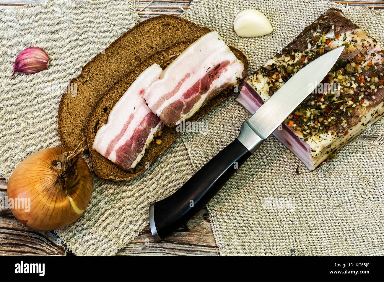 On the table is a slice of bread with two slices of fresh salted rust ...