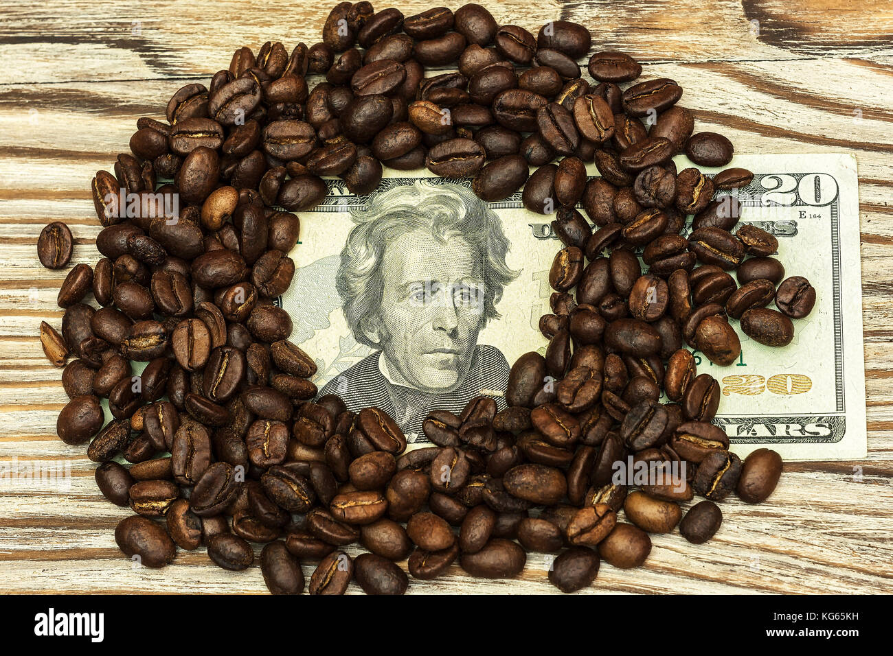 On a wooden background is a money bill and coffee beans Stock Photo - Alamy