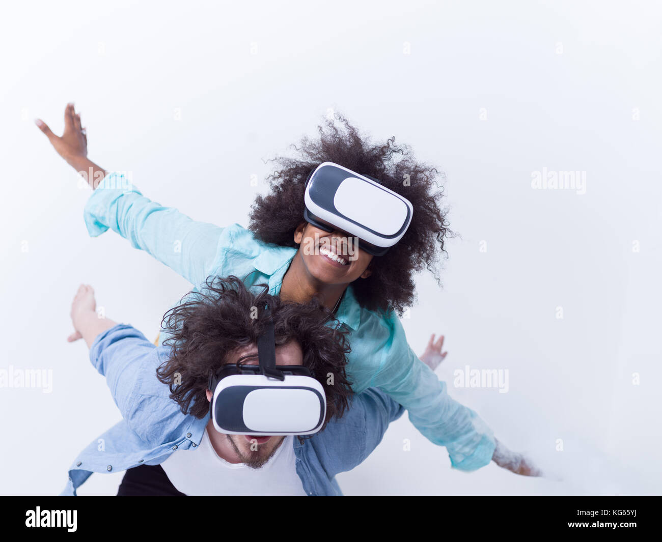 Happy multiethnic couple getting experience using VR headset glasses of ...