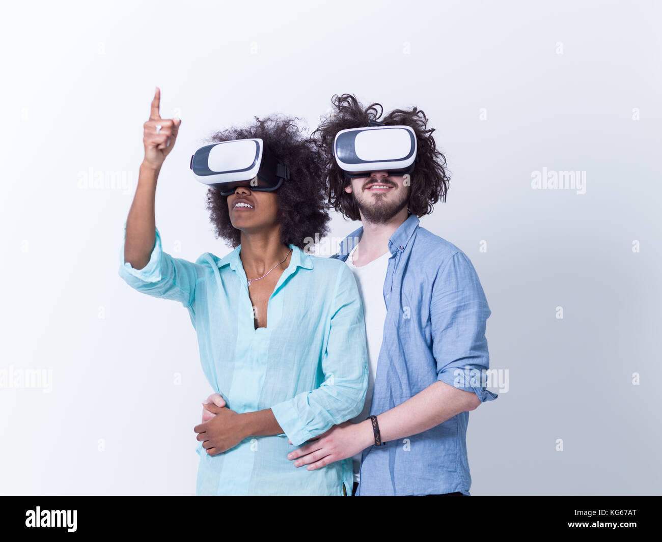 Happy multiethnic couple getting experience using VR headset glasses of ...