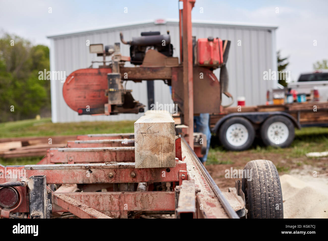 Beams being cut and dressed in a timber yard on a portable milling ...