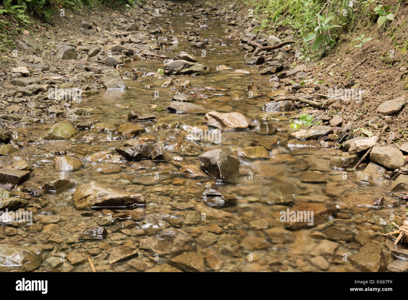 bottom of river valley in a mountain terrain with pebble rocks Stock ...