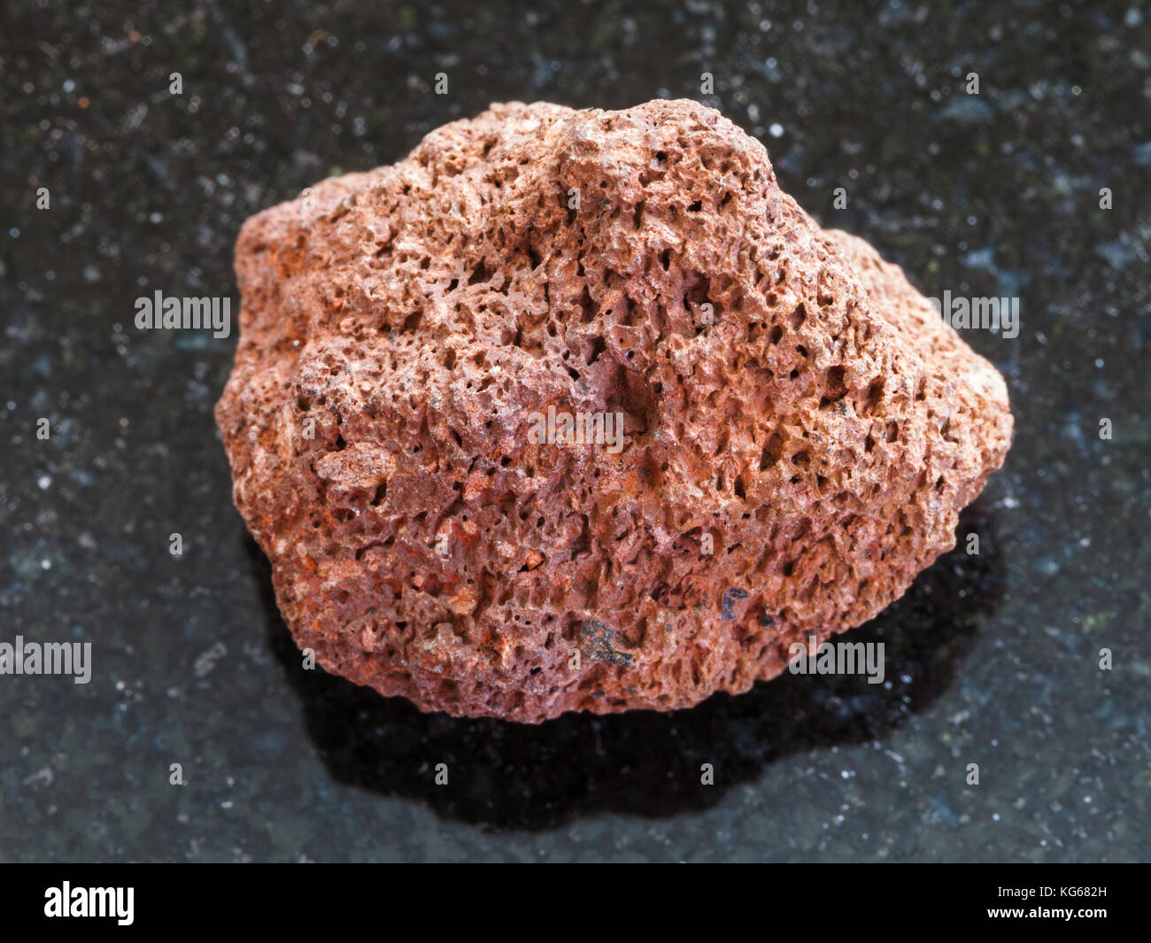 macro shooting of natural mineral rock specimen - tumbled red pumice ...