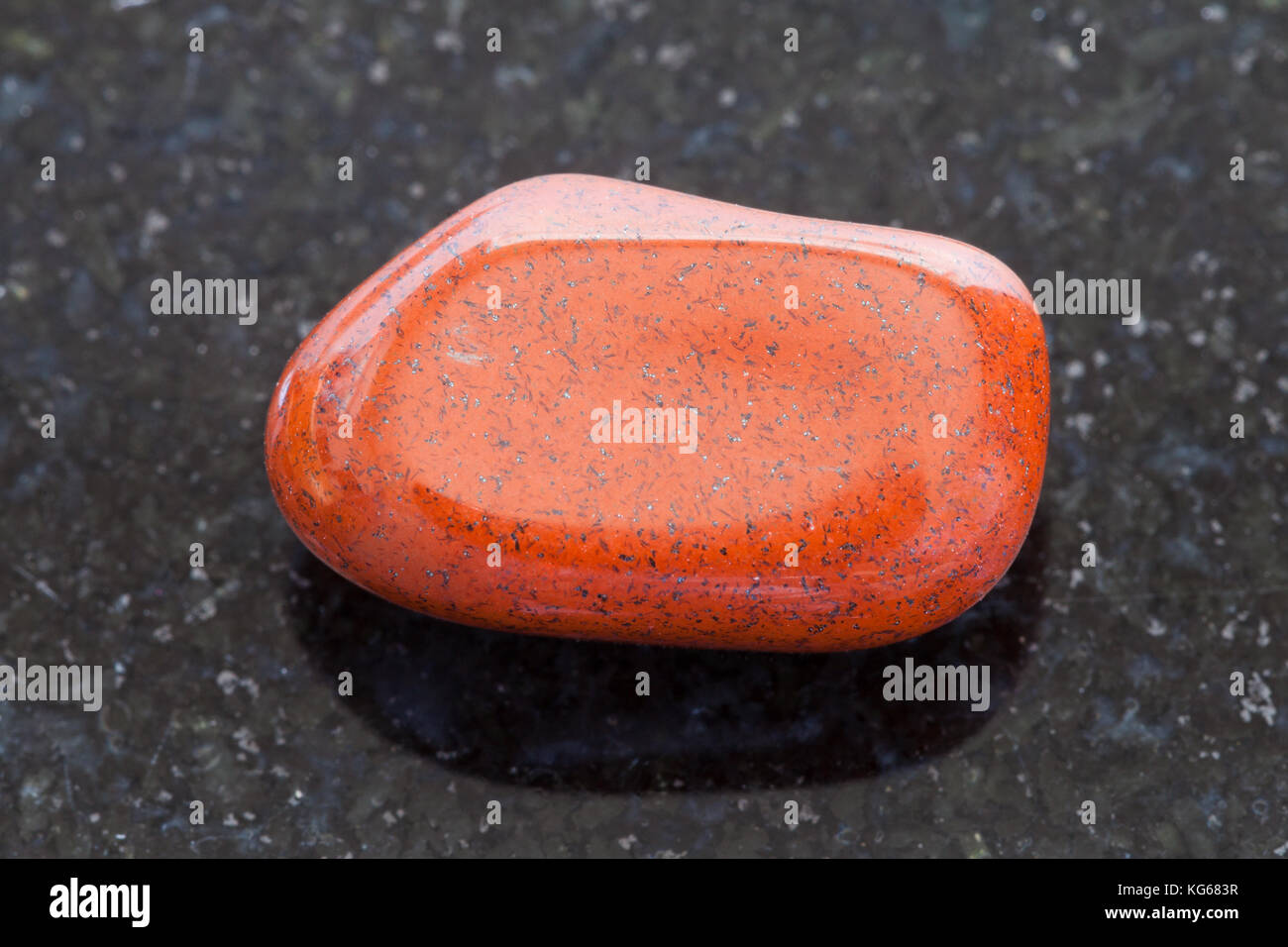 macro shooting of natural mineral rock specimen - tumbled red jasper ...