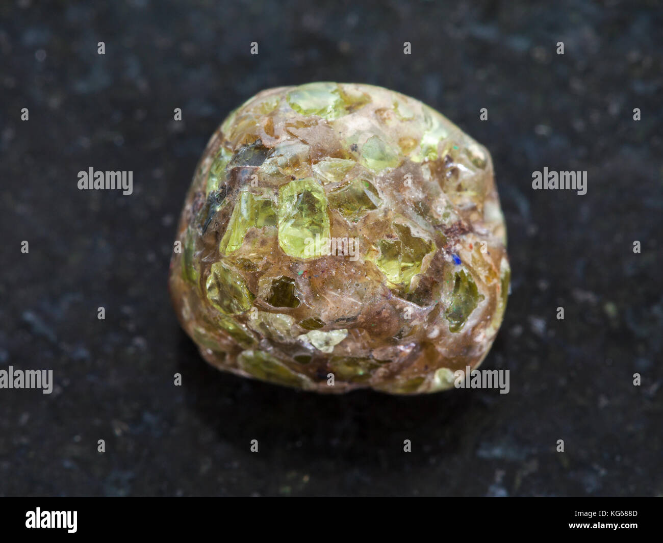 macro shooting of natural mineral rock specimen - tumbled Peridot ...
