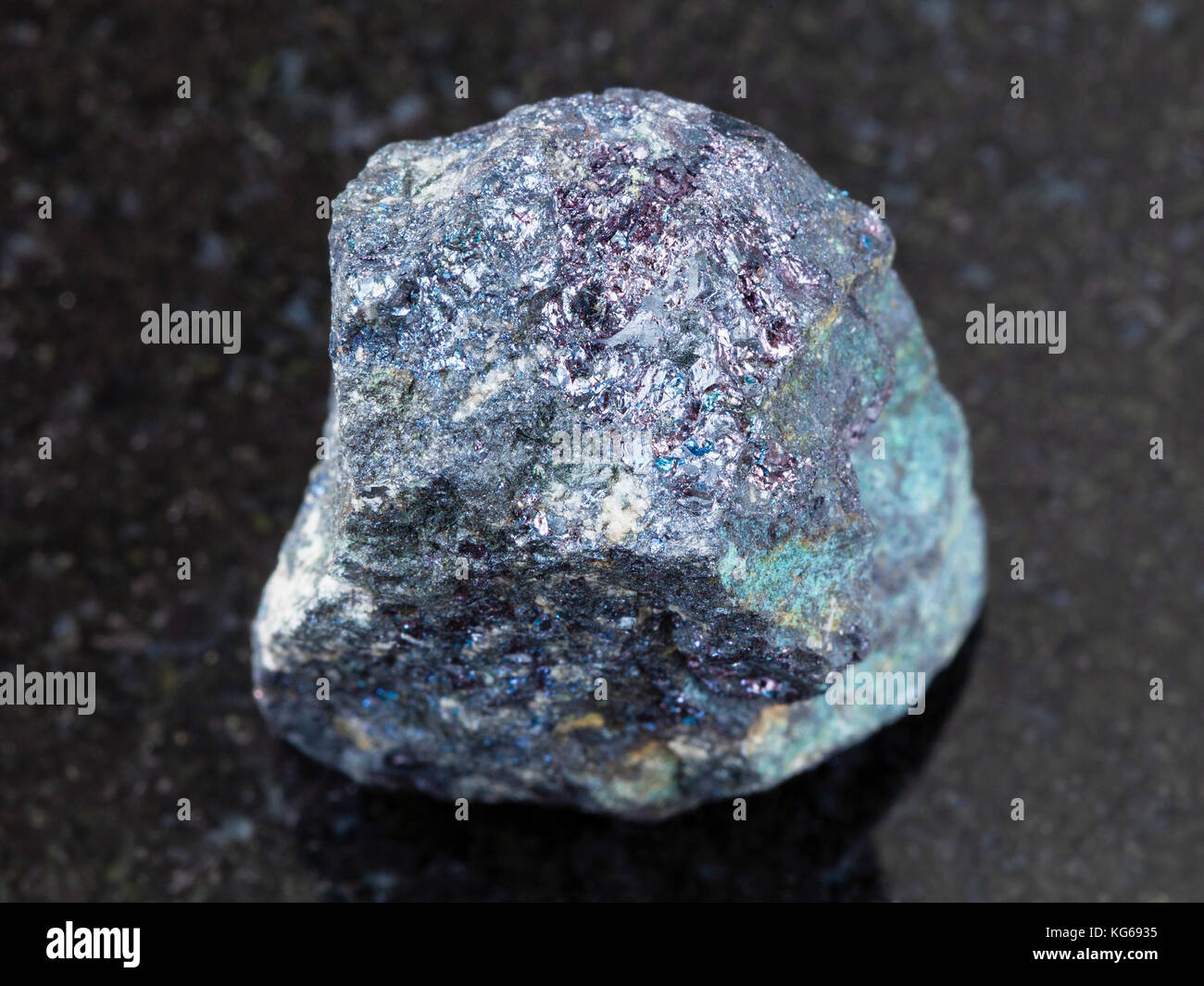 macro shooting of natural mineral rock specimen - bornite stone on dark ...