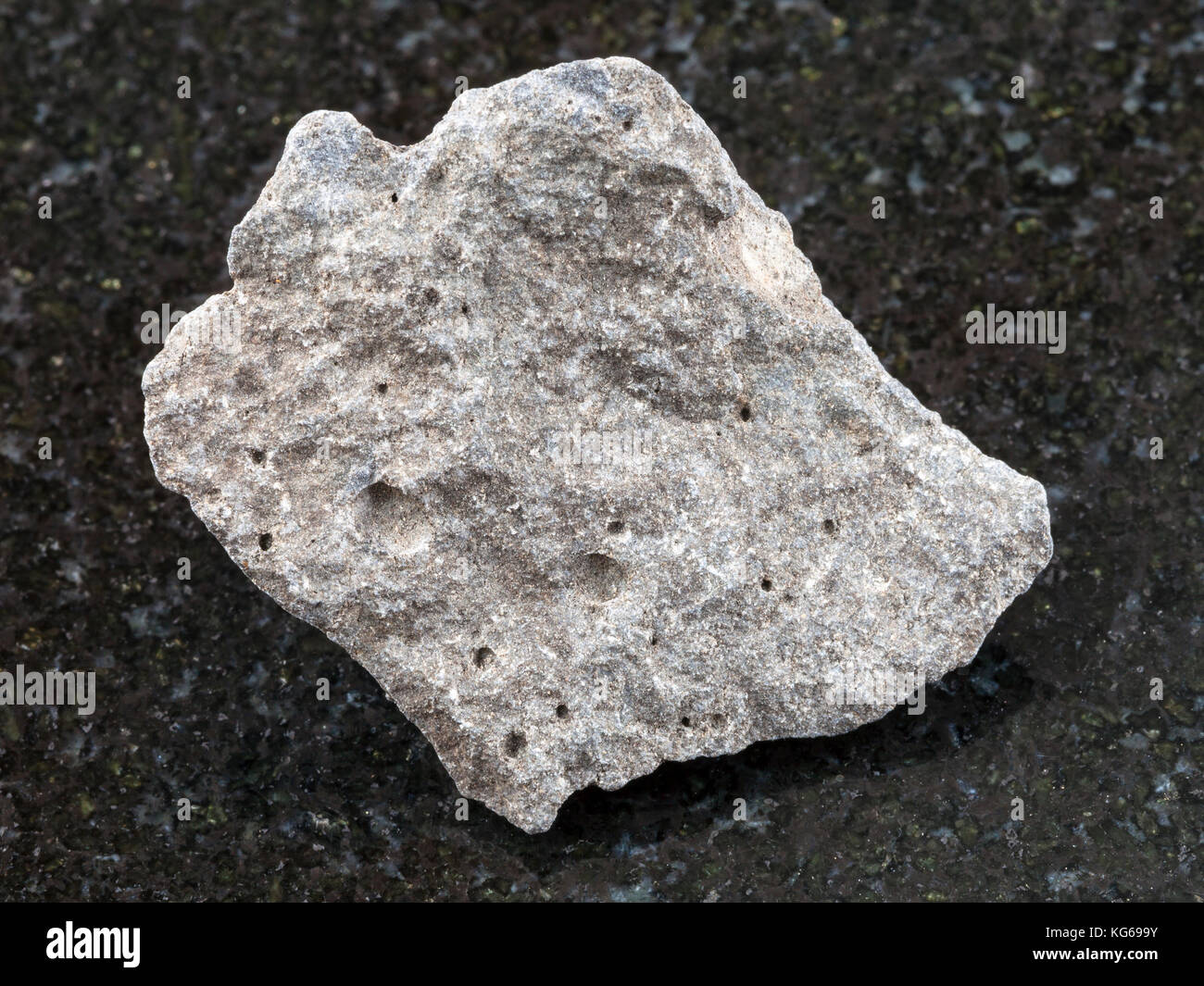macro shooting of natural mineral rock specimen - pebble of gray basalt ...