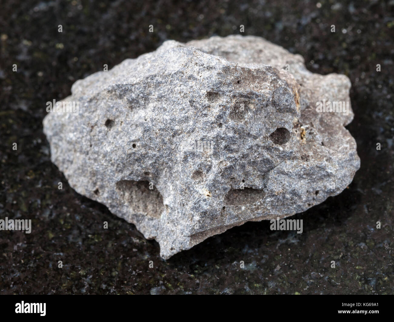 macro shooting of natural mineral rock specimen - piece of gray basalt ...