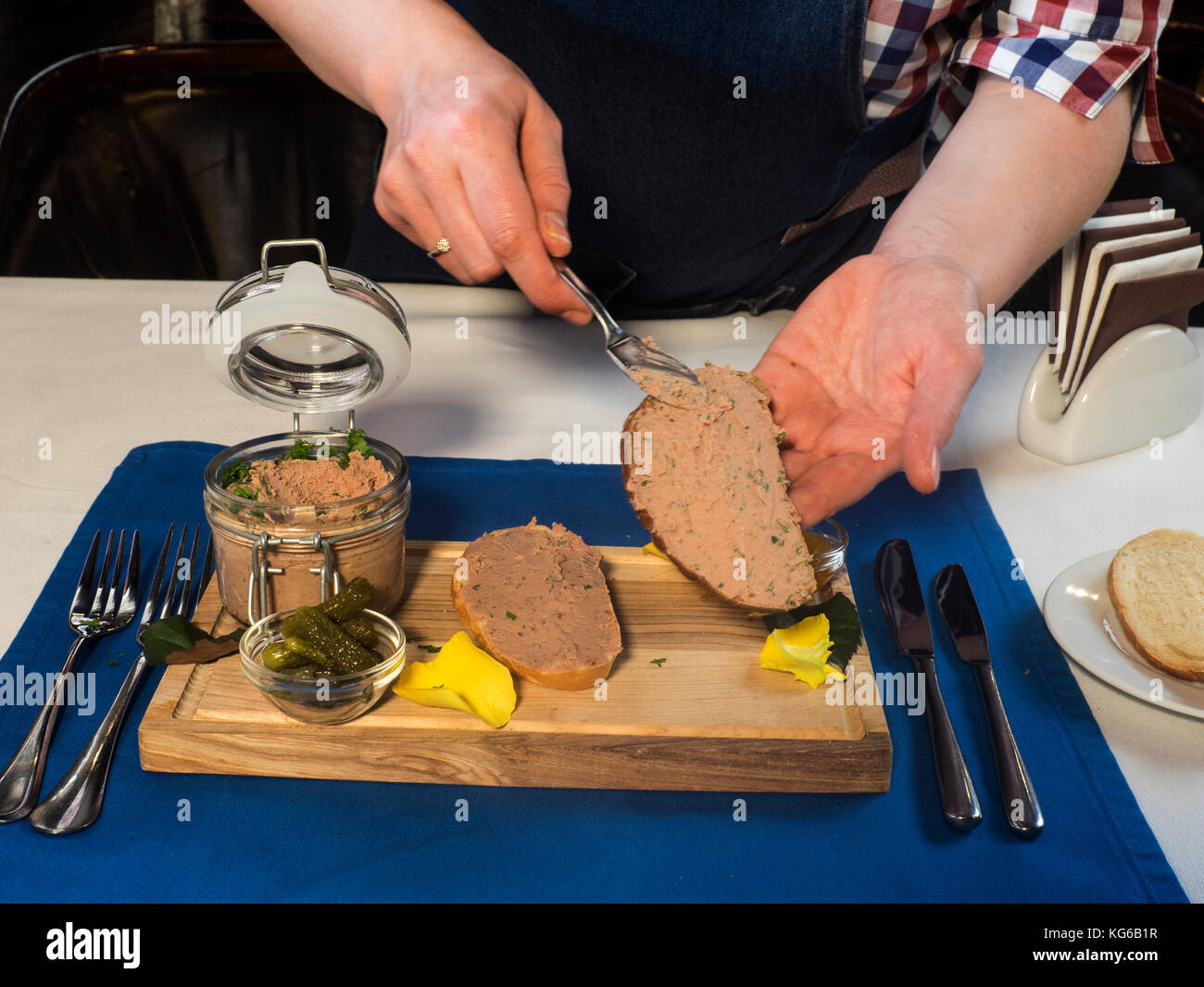 Woman spreads liver paste on bread Stock Photo - Alamy