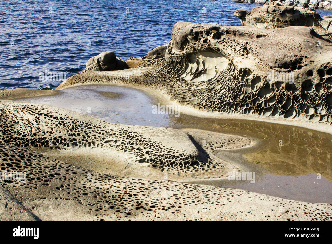 Sandstone rocks carved by the ocean Stock Photo - Alamy