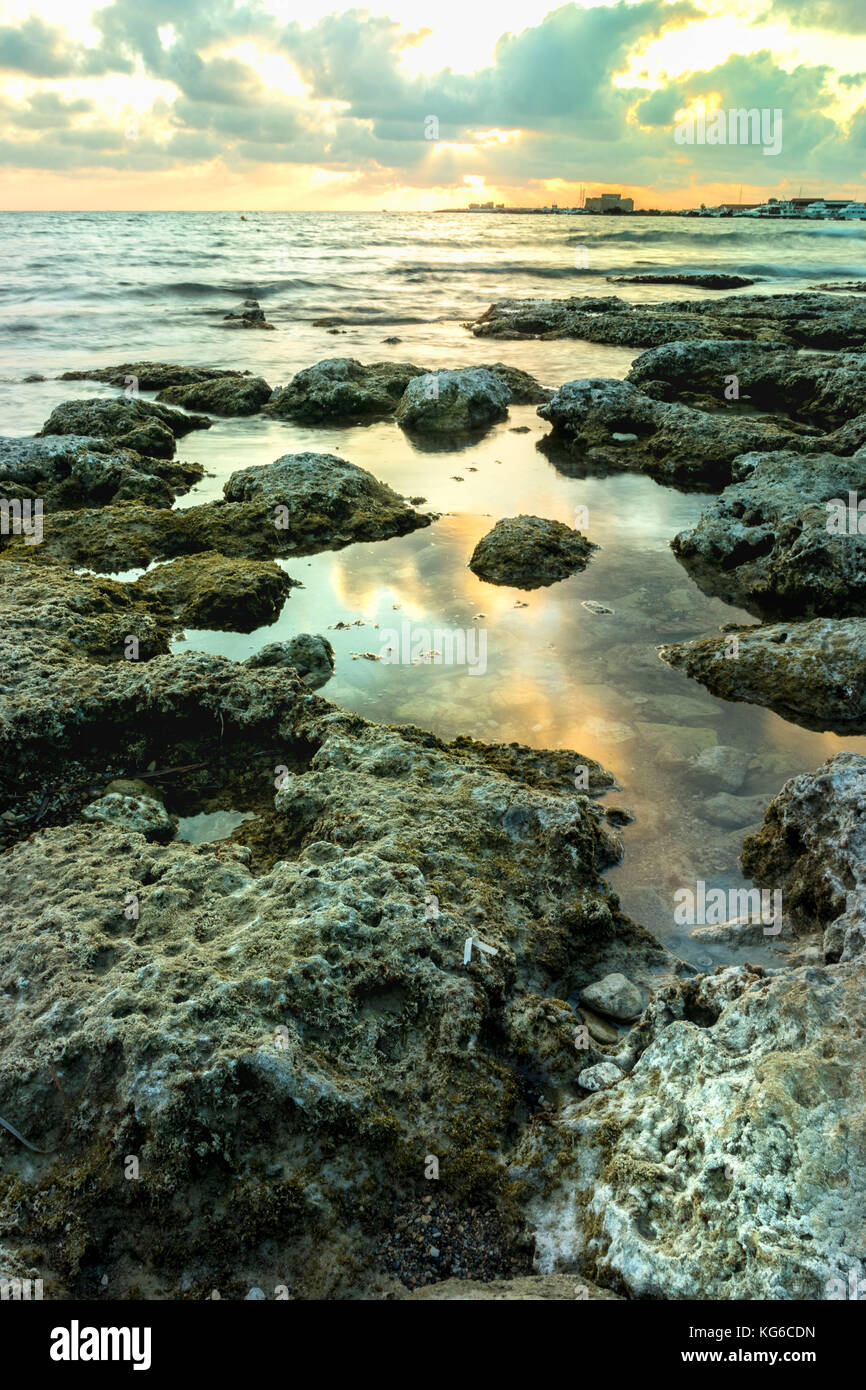 receding tide from rocky shore at sunset Stock Photo - Alamy