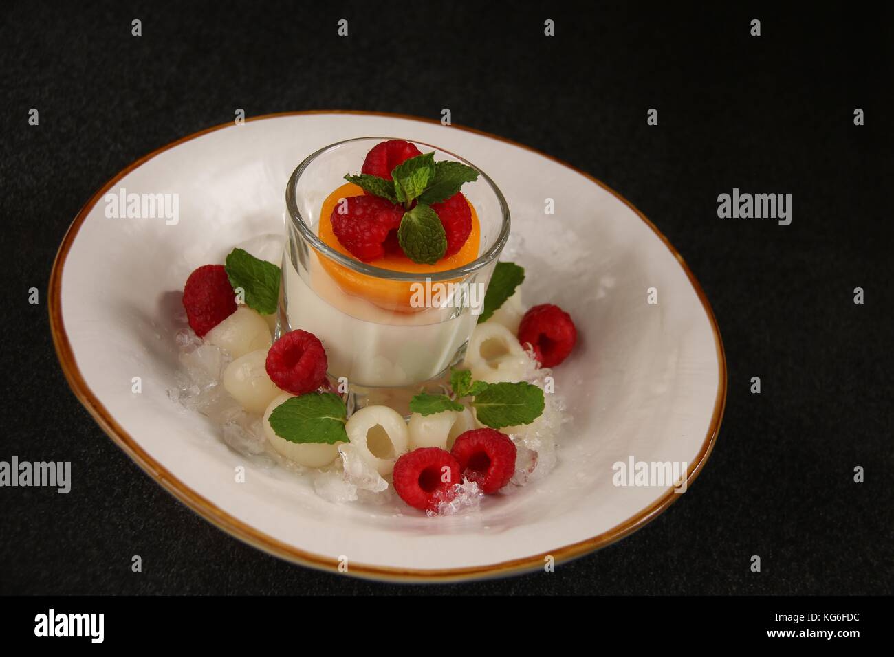 Almond Milk Pudding with Longan, Peach and Raspberry Stock Photo - Alamy