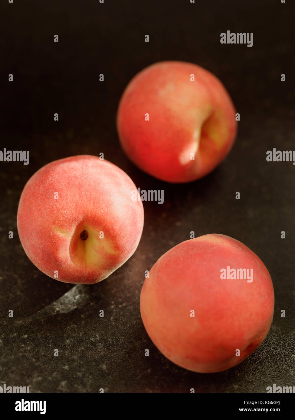 Three peaches on black background Stock Photo - Alamy